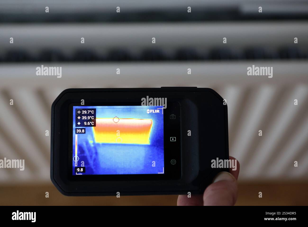 Thermal imaging camera showing a central heating radiator FLIR showing ...