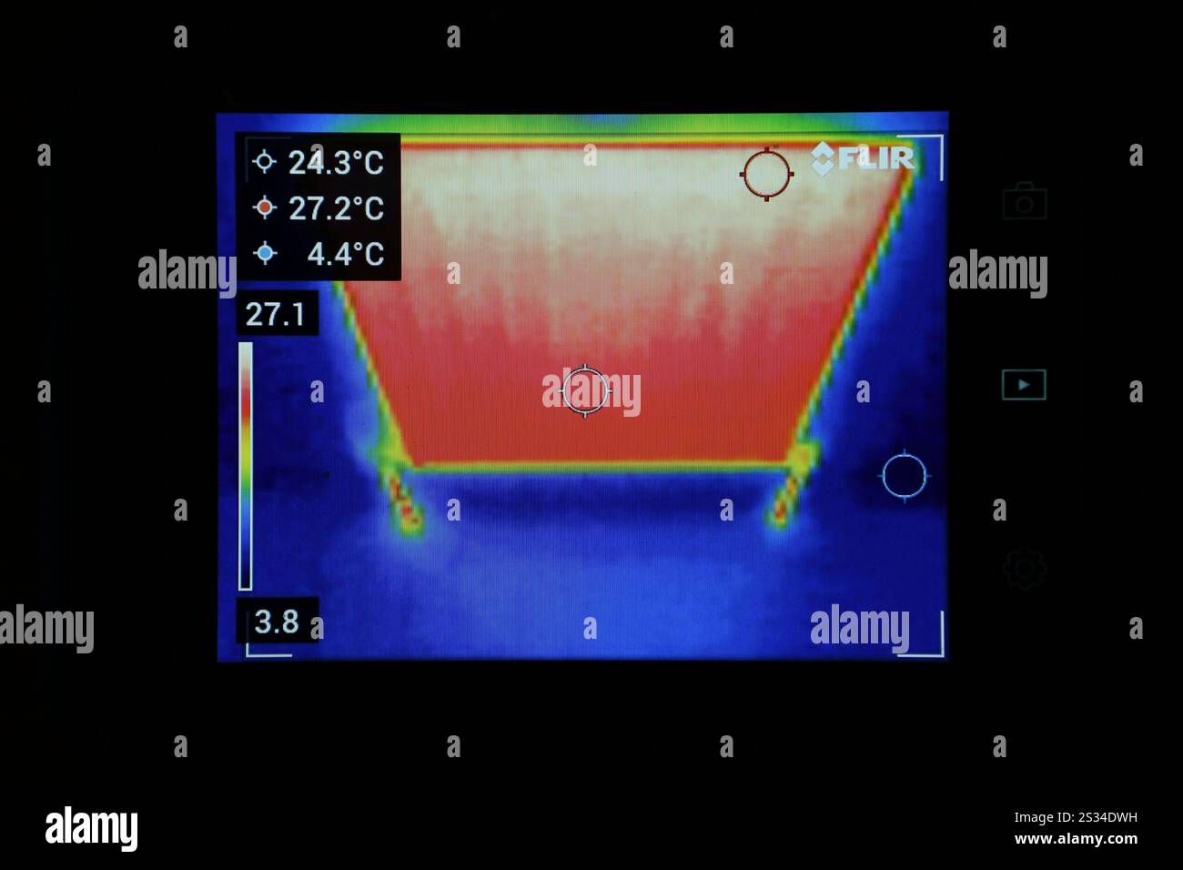 Thermal imaging camera showing a central heating radiator FLIR showing ...