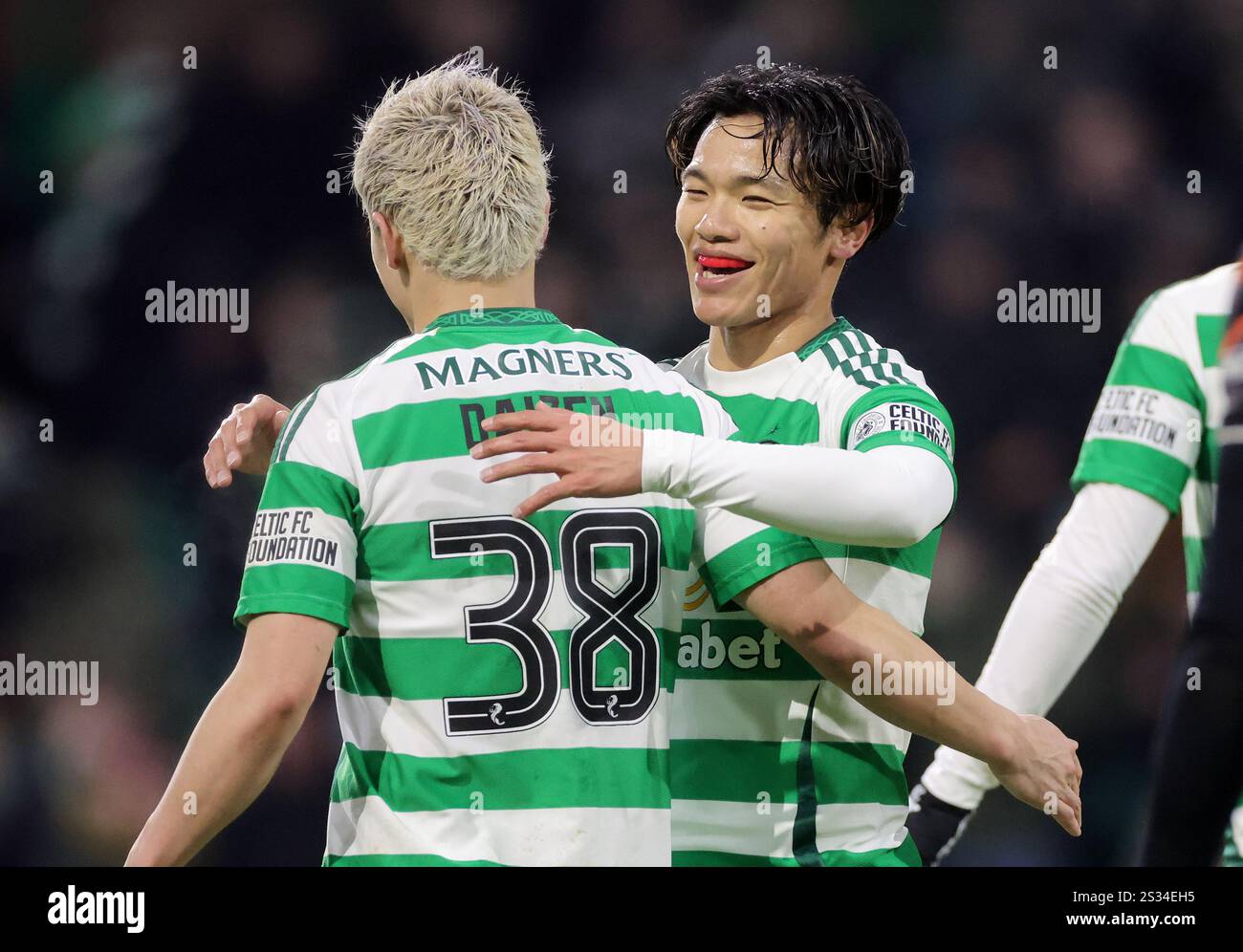 Celtic's Reo Hatate (right) celebrates scoring their side's second goal ...