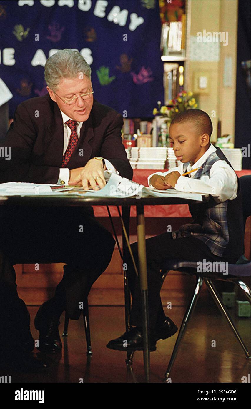 U.S. President Bill Clinton attending tutoring session with young boy ...