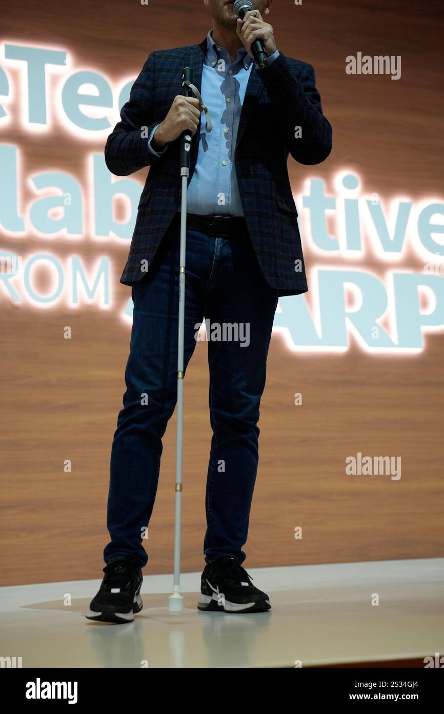 A person holds the WeWALK smart cane, a device that uses the latest in ...