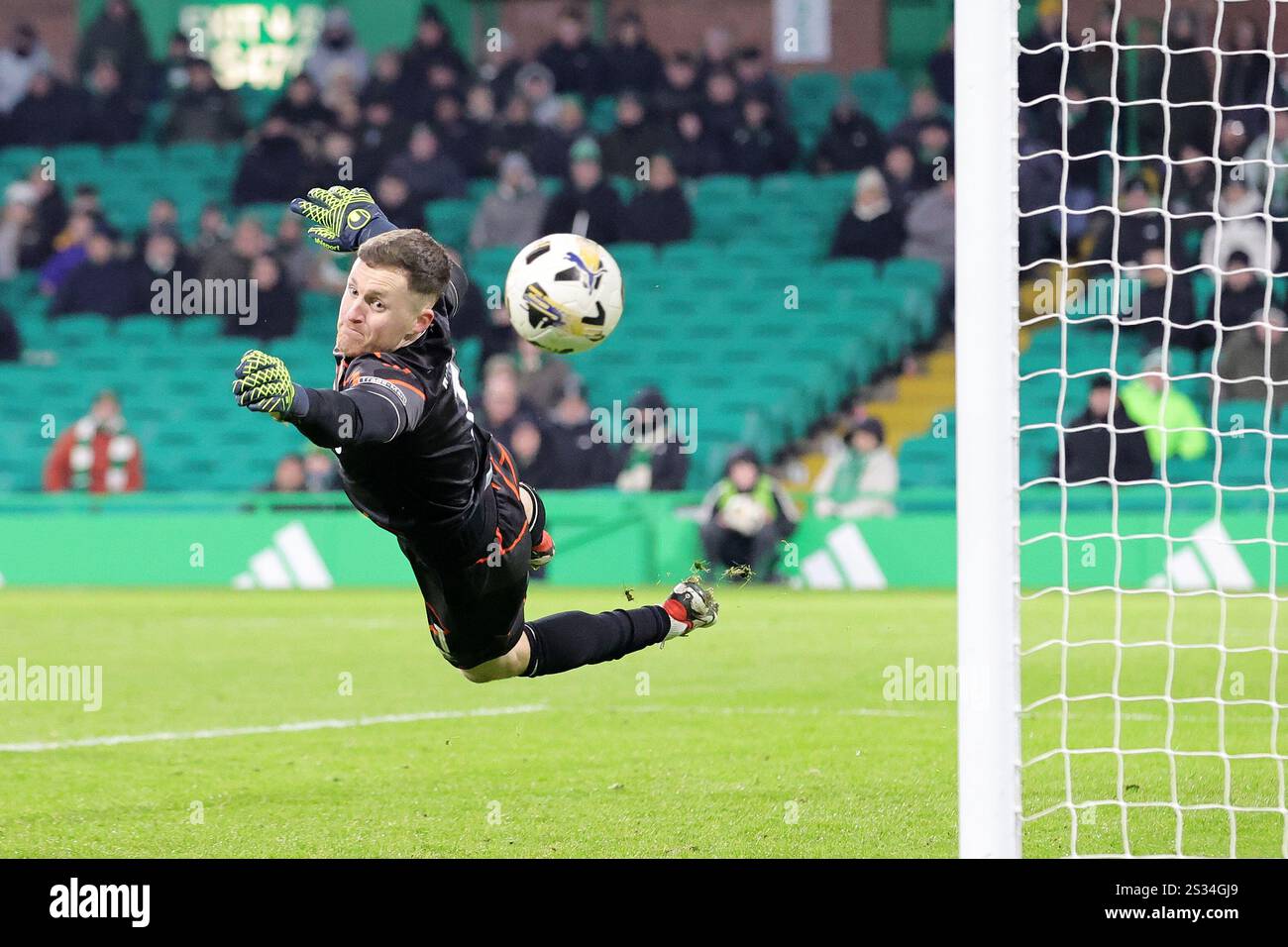 Dundee United goalkeeper Jack Walton saves a shot on goal from Celtic's ...