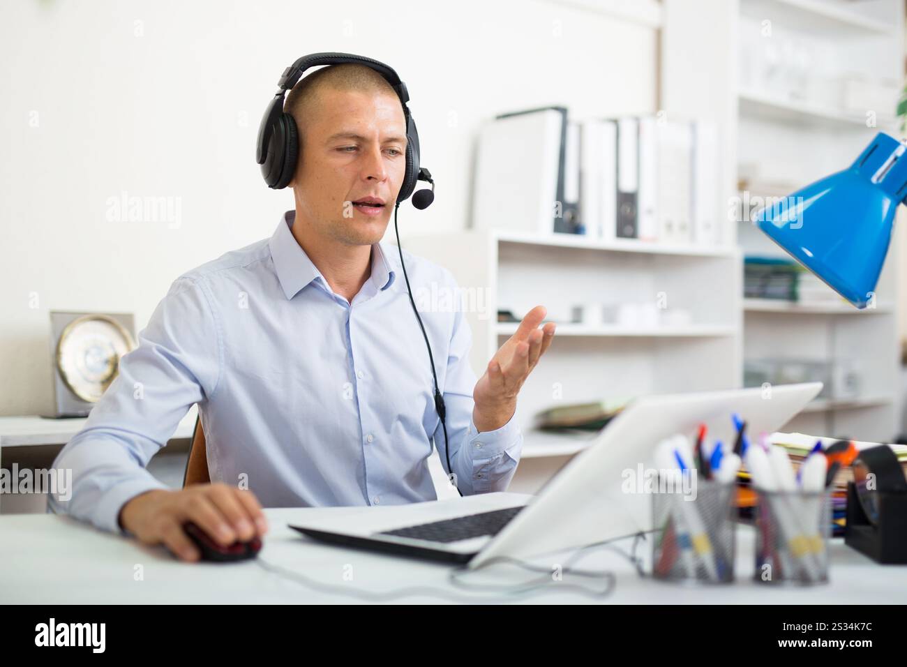Call center man operator with headset talking with client Stock Photo ...
