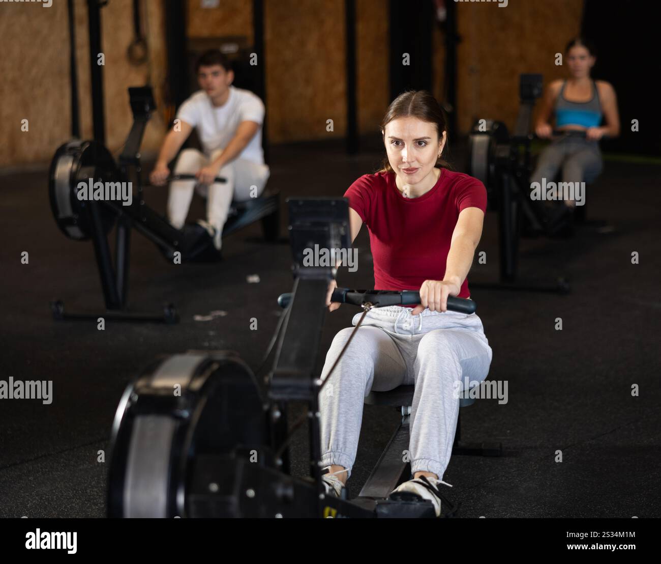 Athletes training on rowing machine hi-res stock photography and images ...