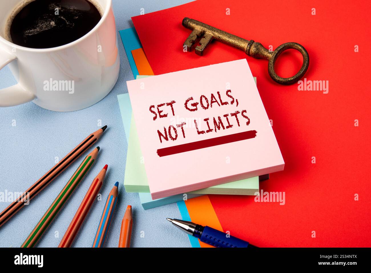 Set goals, not limits. Notepad with text, coffee mug and golden key on ...