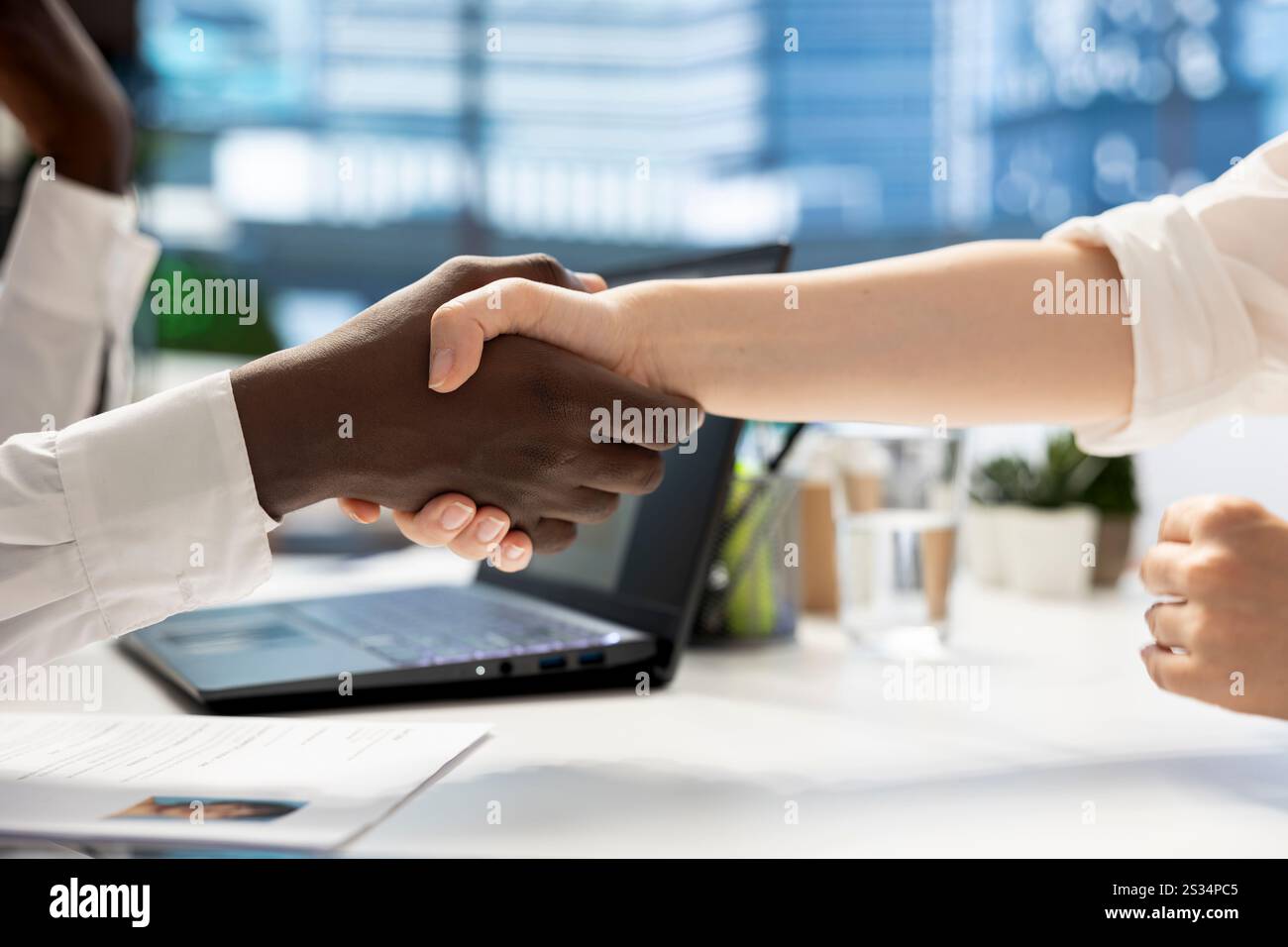 Startup manager shaking hands with newly hired worker, welcoming her ...