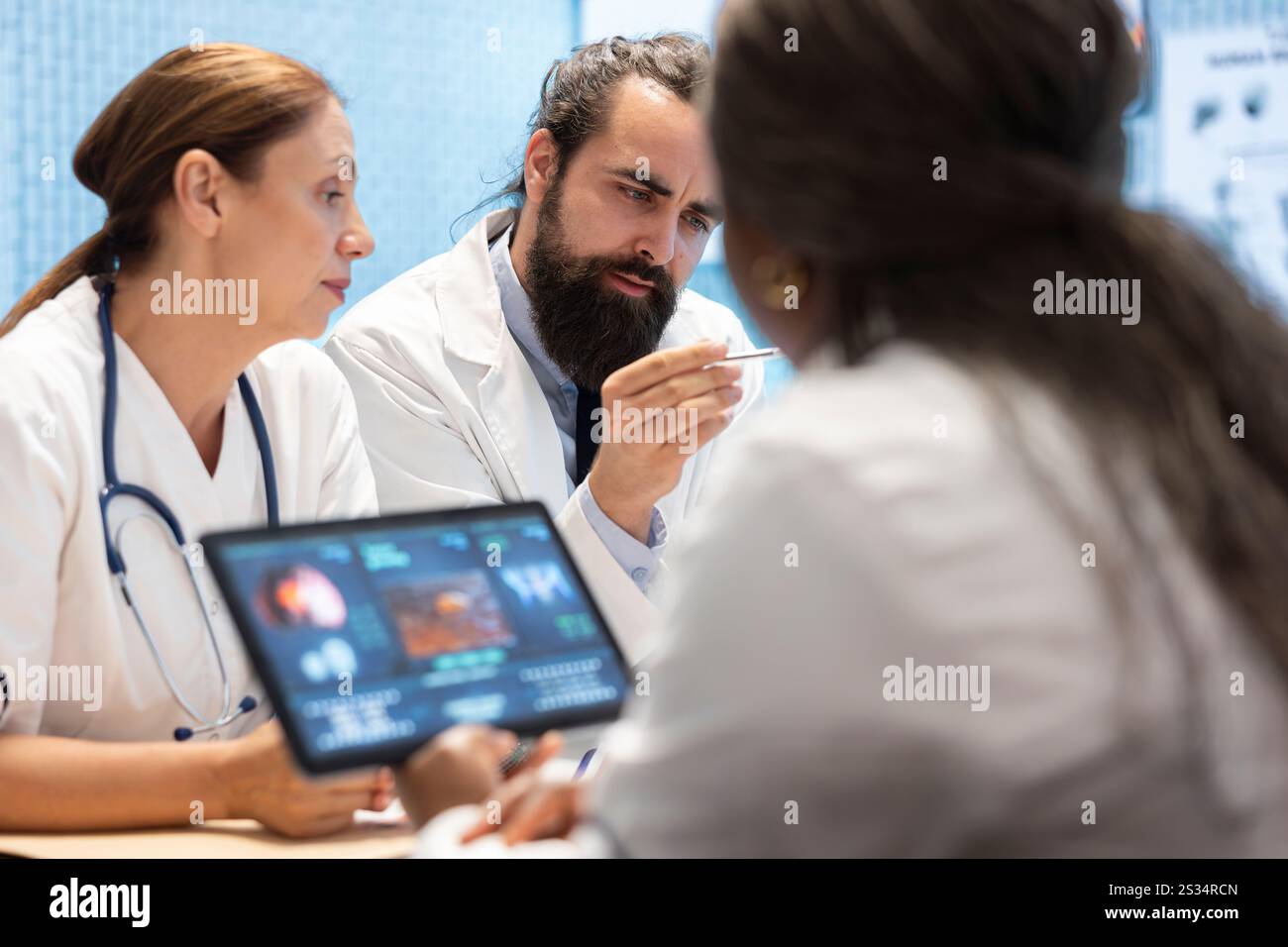 Group of diverse doctors in a treatment center reviewing brain scan results, examining neurology ...