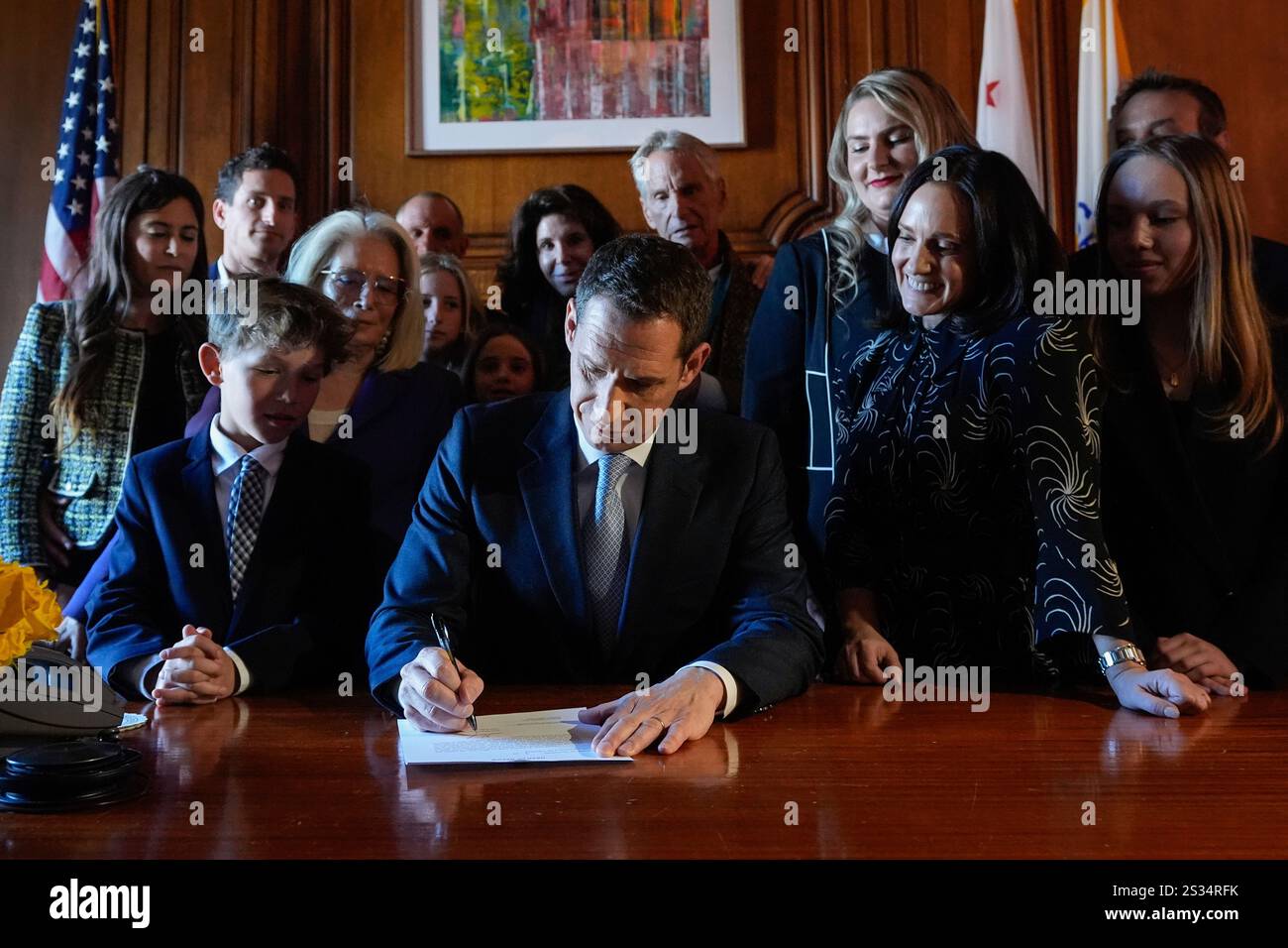 Mayor Daniel Lurie, center, is surrounded by family and friends as he ...