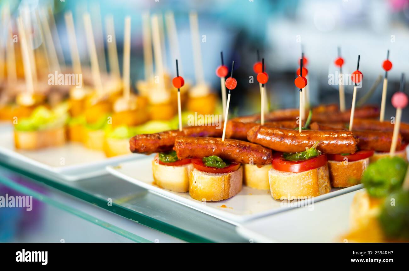 Pinchos de chistorra - Spanish snack or bar snack fried sausage, tomato ...