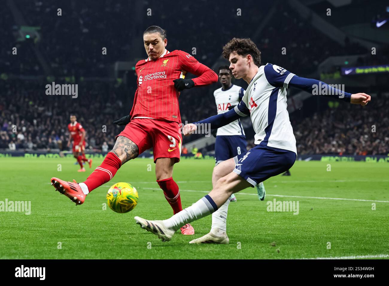 Archie Gray of Tottenham Hotspur clears the ball despite pressure from ...