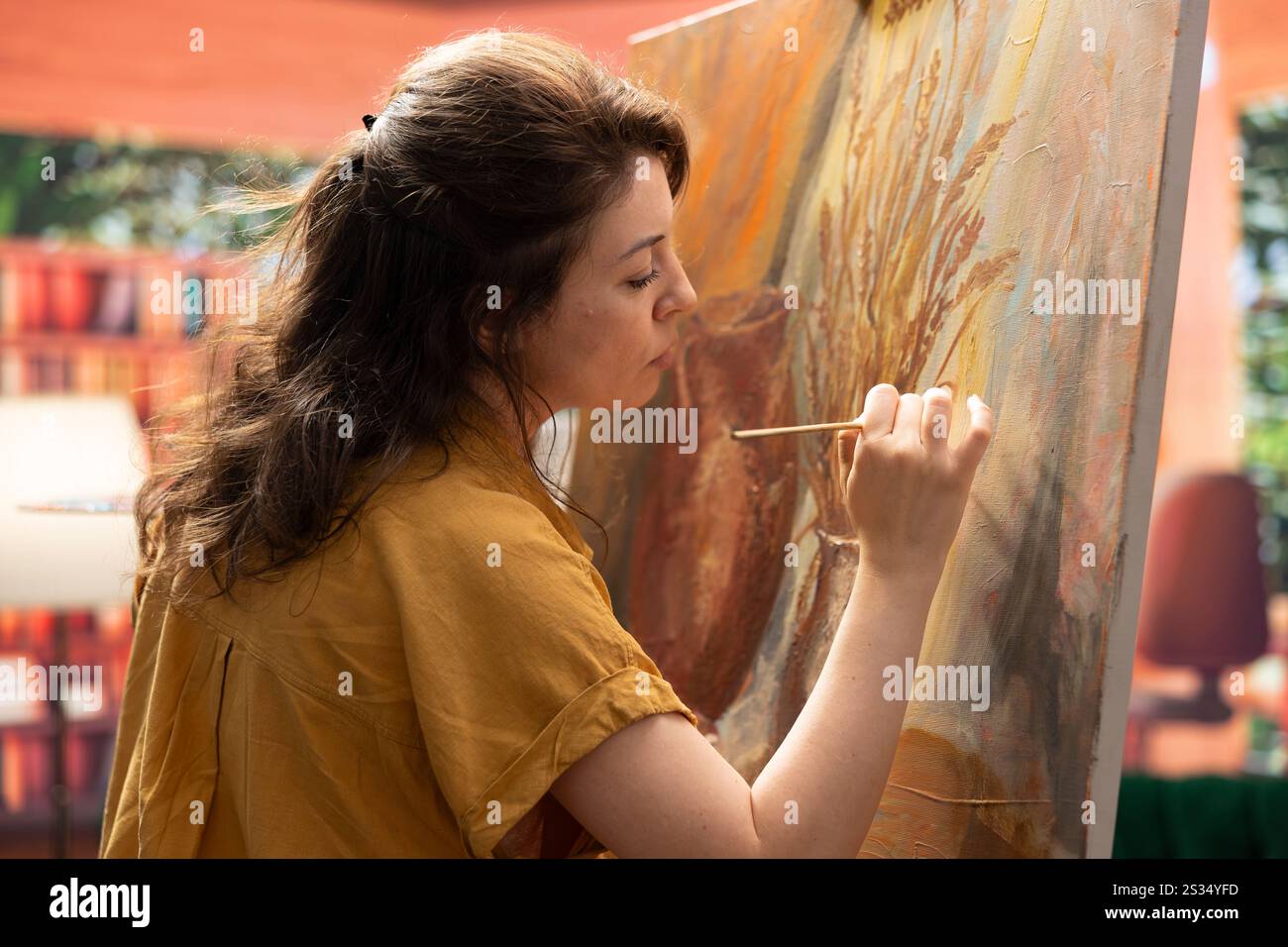 Inspired artist works on a canvas to create a masterpiece in atelier ...