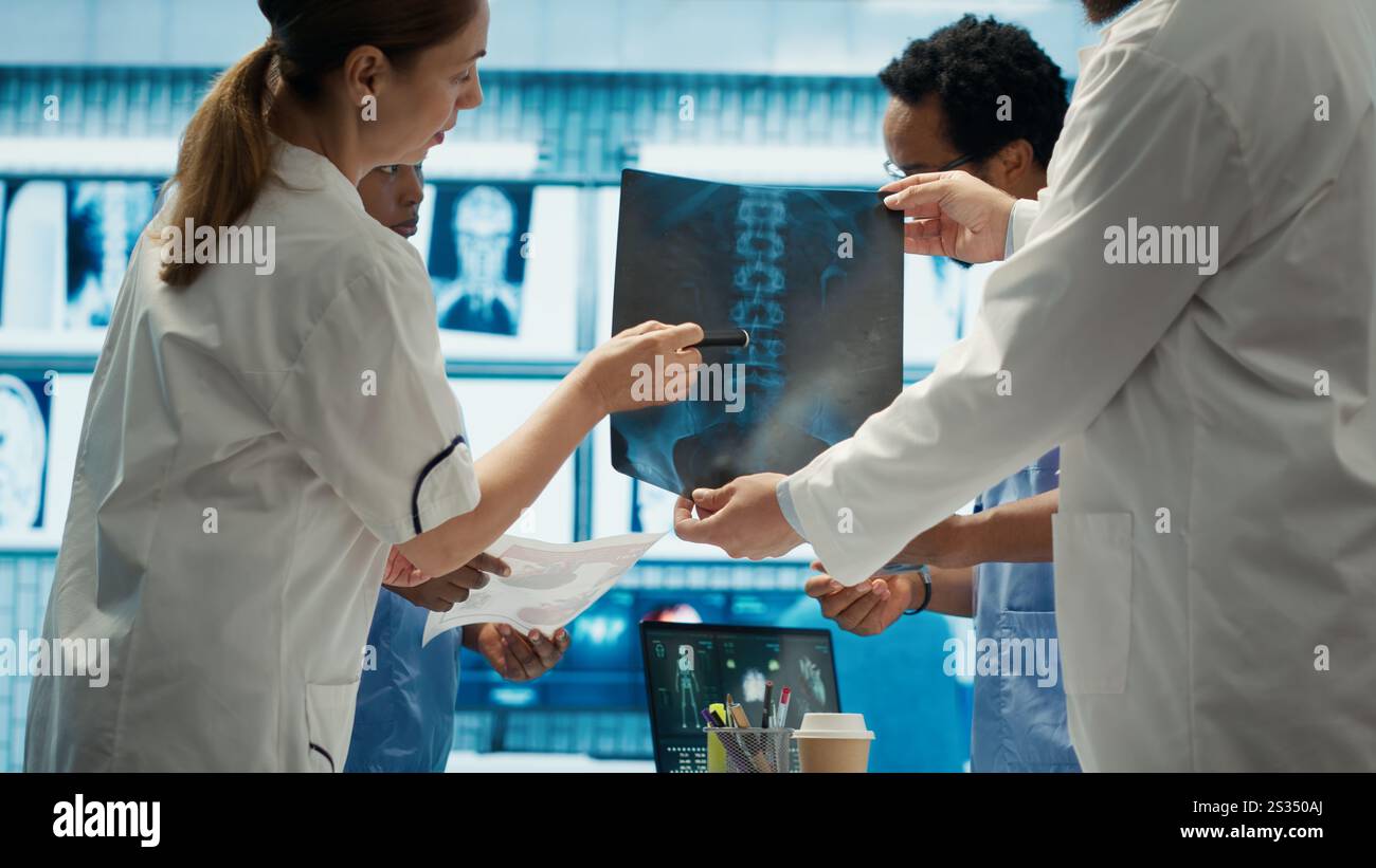 Doctors analyze human anatomy scans in a treatment center, teamwork and ...