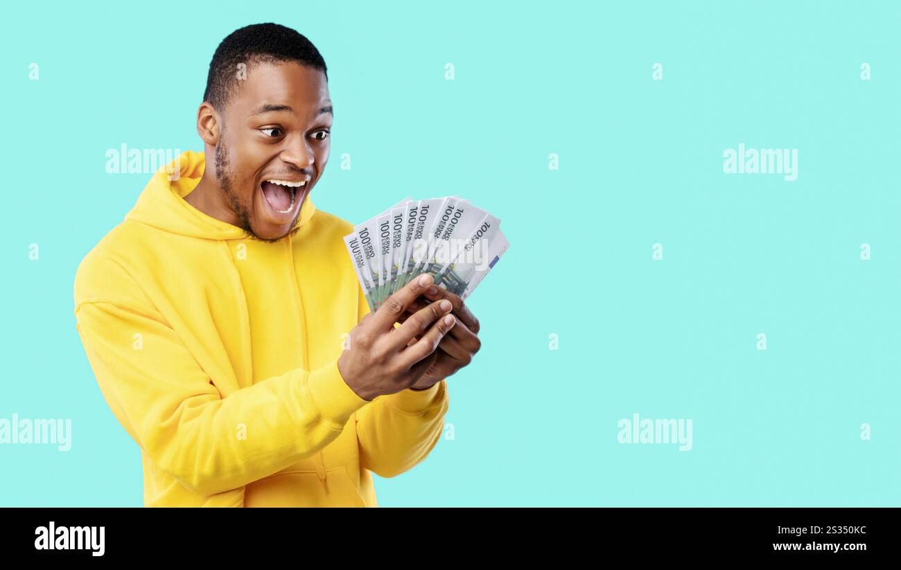 Joyful African American Guy Shouting Holding Euro Money, Blue ...