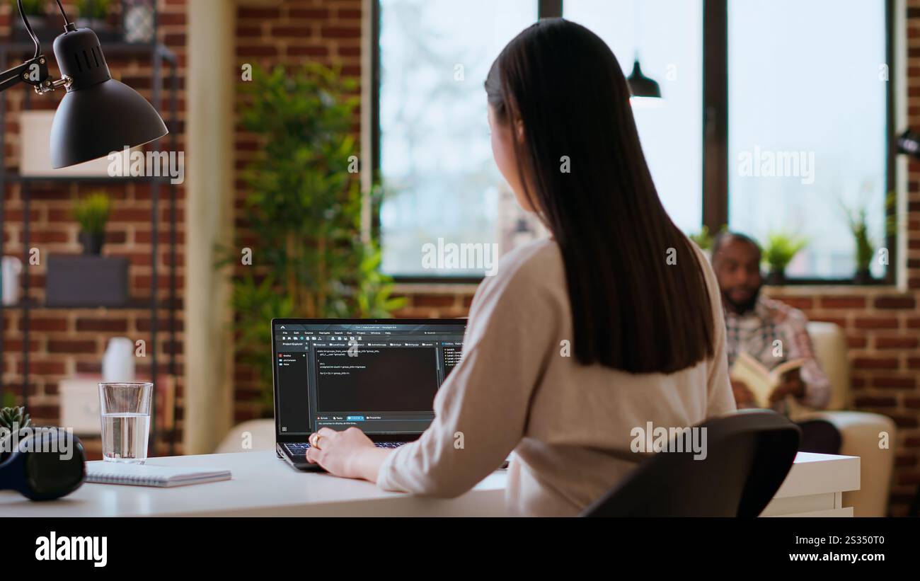 Professional asian software engineer is working remotely typing code on ...