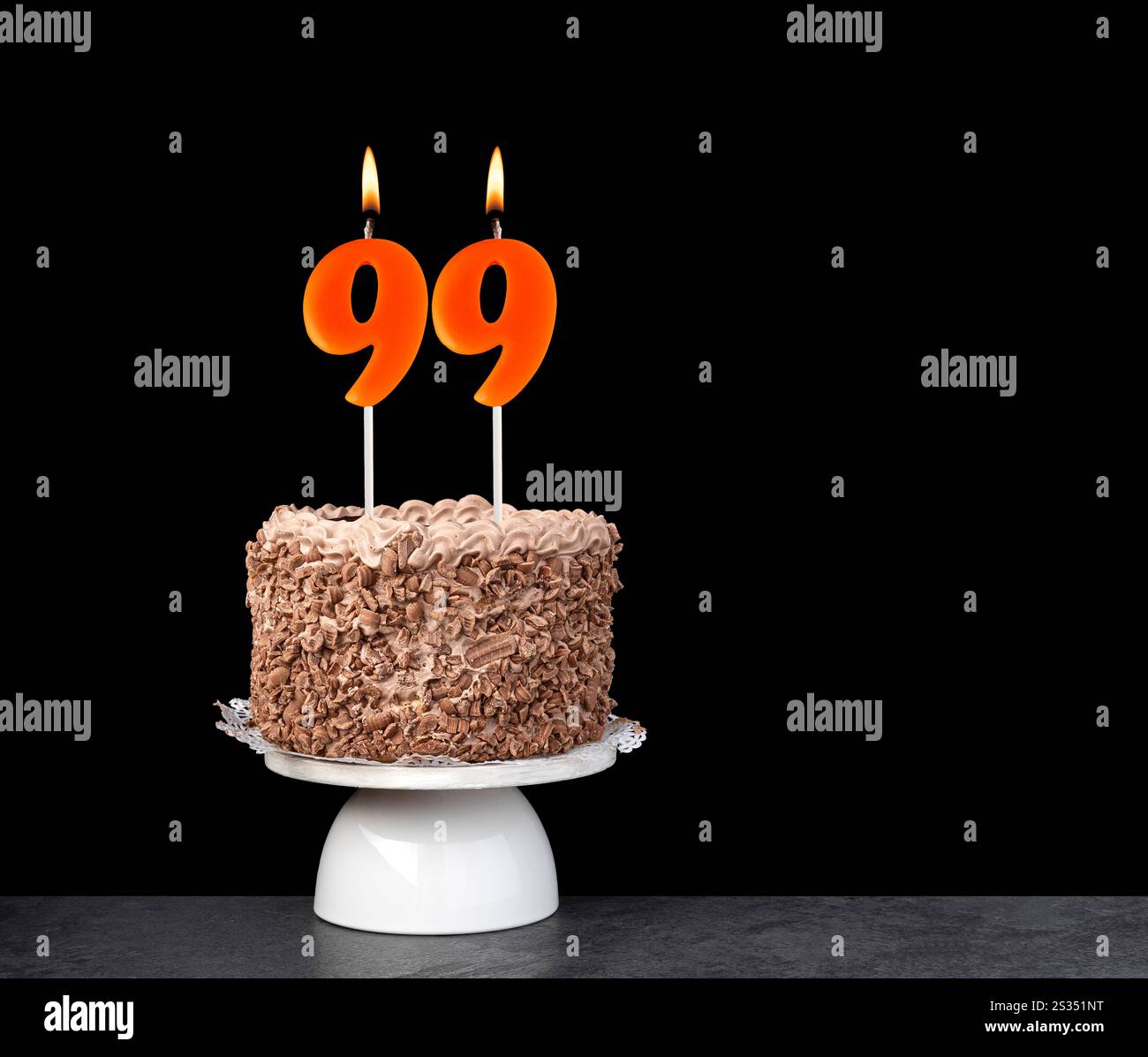 Birthday cake with number 99 candle - Anniversary card on a black ...