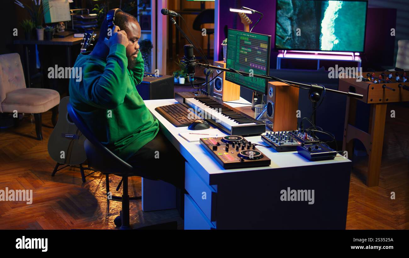 Artist composer recording a new track on his home studio microphone ...