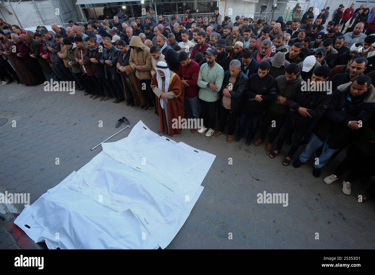 Gaza. 8th Jan, 2025. People pray for victims at a hospital in Deir al ...