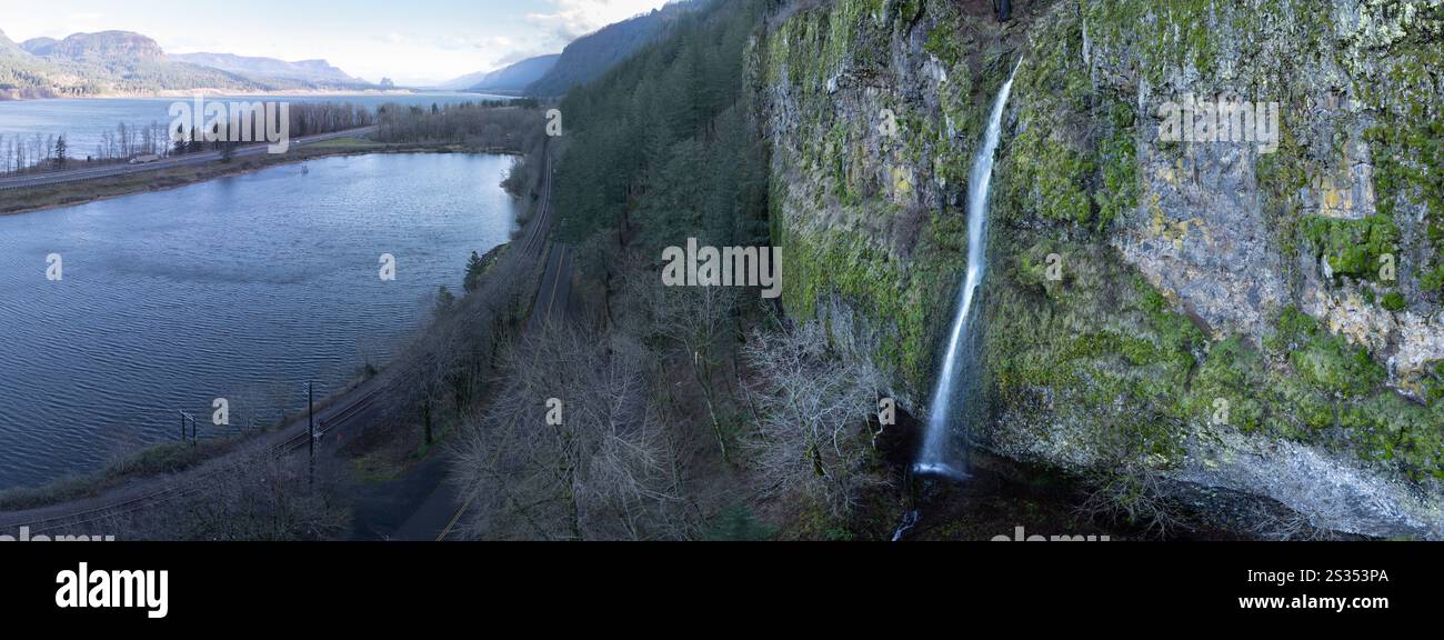 A beautiful waterfall flows out of the Cascade mountains and into the ...