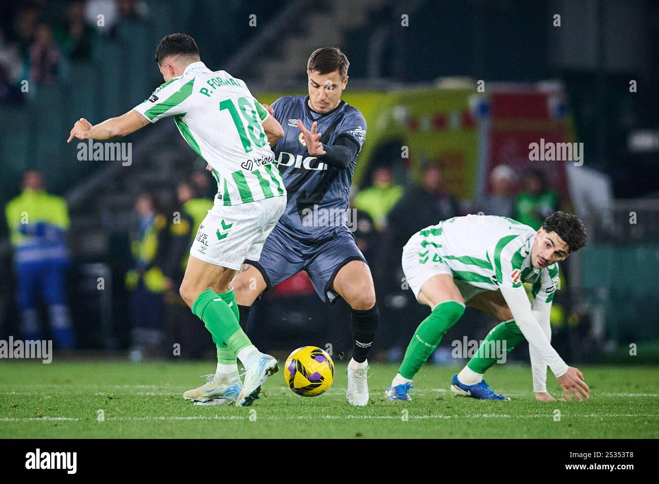 Real Betis Balompie's Johnny Cardoso (r), Pablo Fornals (l) and Rayo Vallecano's Oscar Trejo (c ...