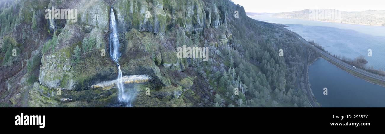 A beautiful waterfall flows out of the Cascade mountains and into the ...
