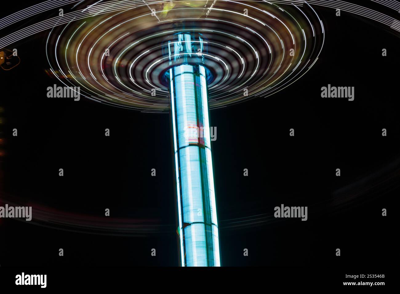 A tall, blue structure with lights on top. The lights are spinning and ...