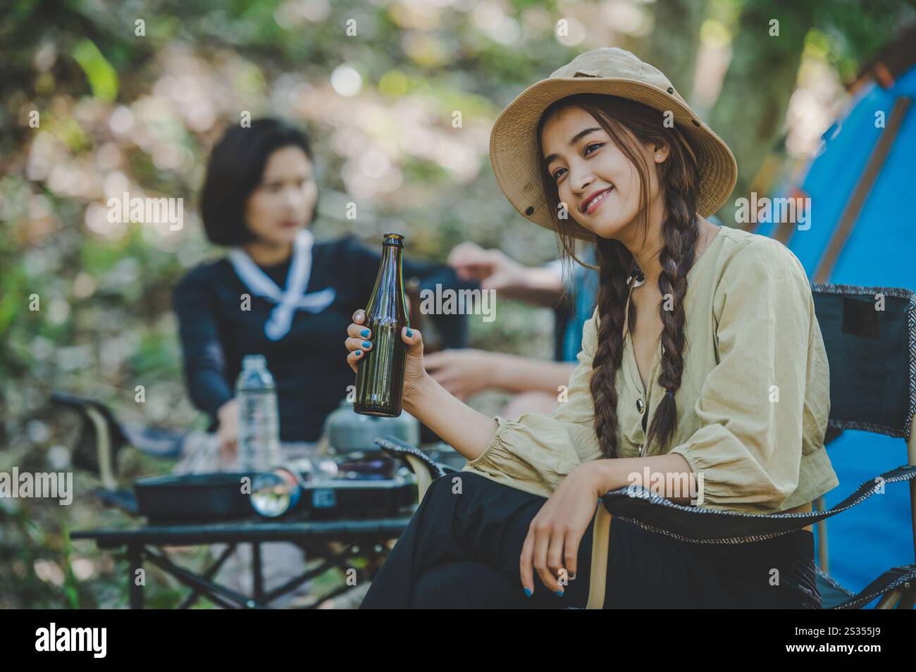 Group beautiful Asian women friends travelers relaxing in camp chairs ...