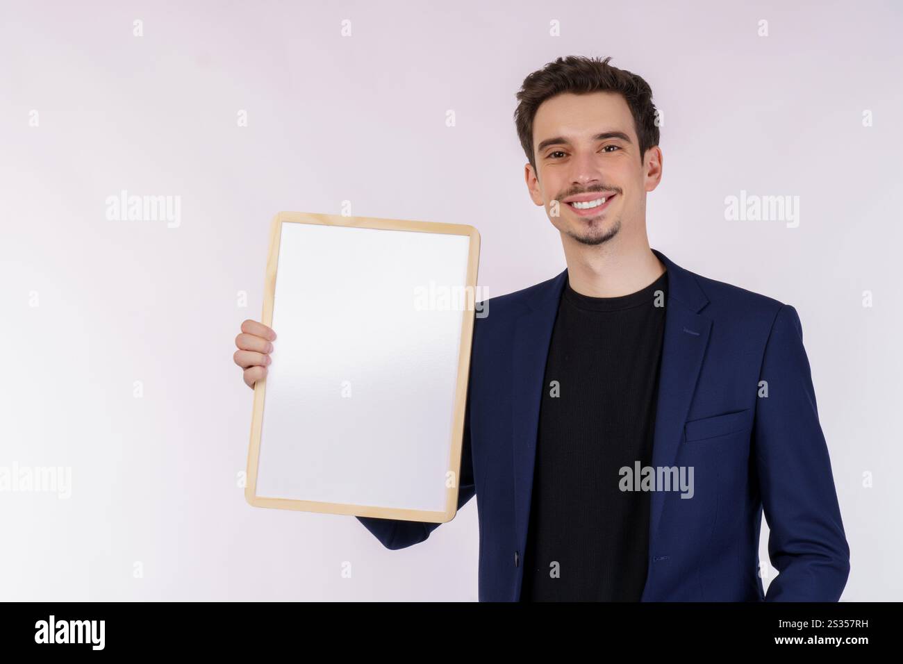 Portrait of happy businessman showing blank signboard on isolated white ...