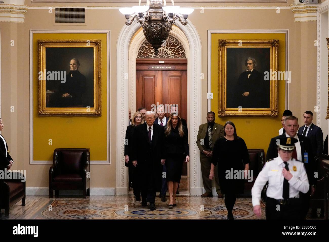President-elect Donald Trump, front, and his wife Melania, walk with ...