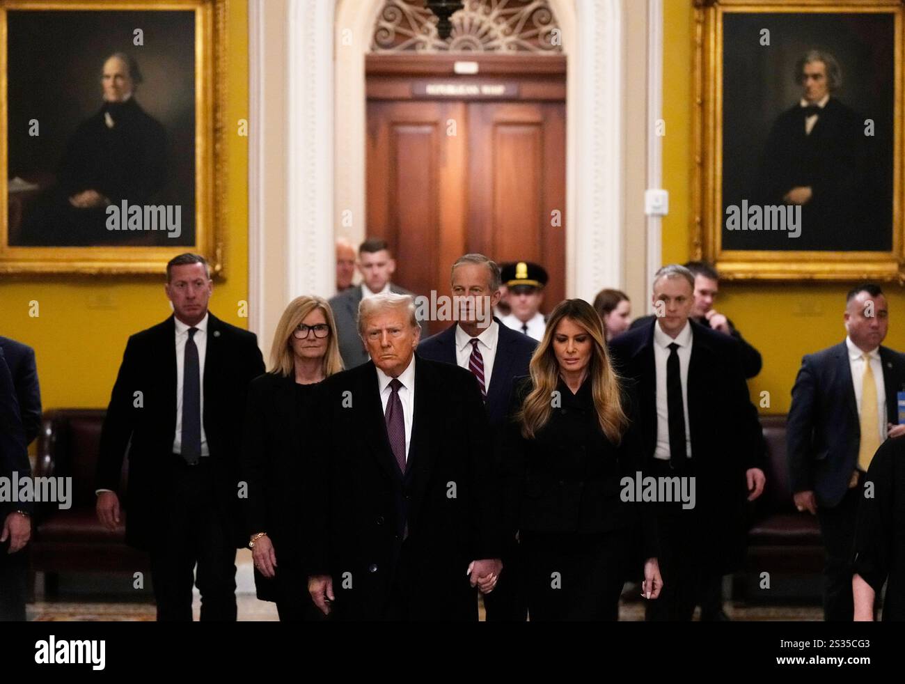 President-elect Donald Trump, front, and his wife Melania, walk with ...