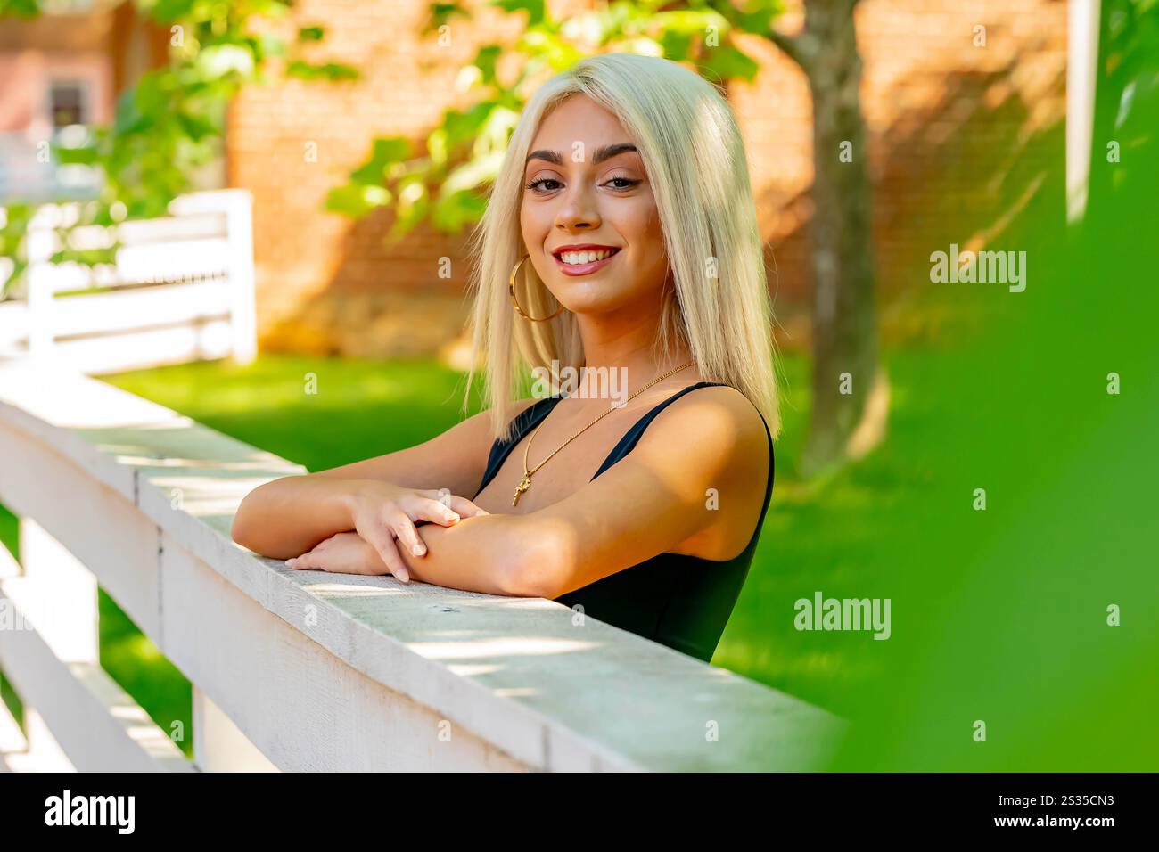 A gorgeous blonde woman strolls through a quaint small town as she ...