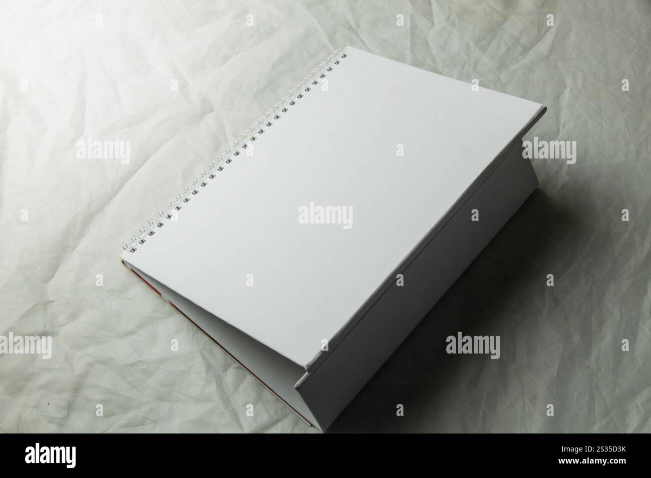 Corner view of textured spiral desk calendar blank paper hard cover on ...