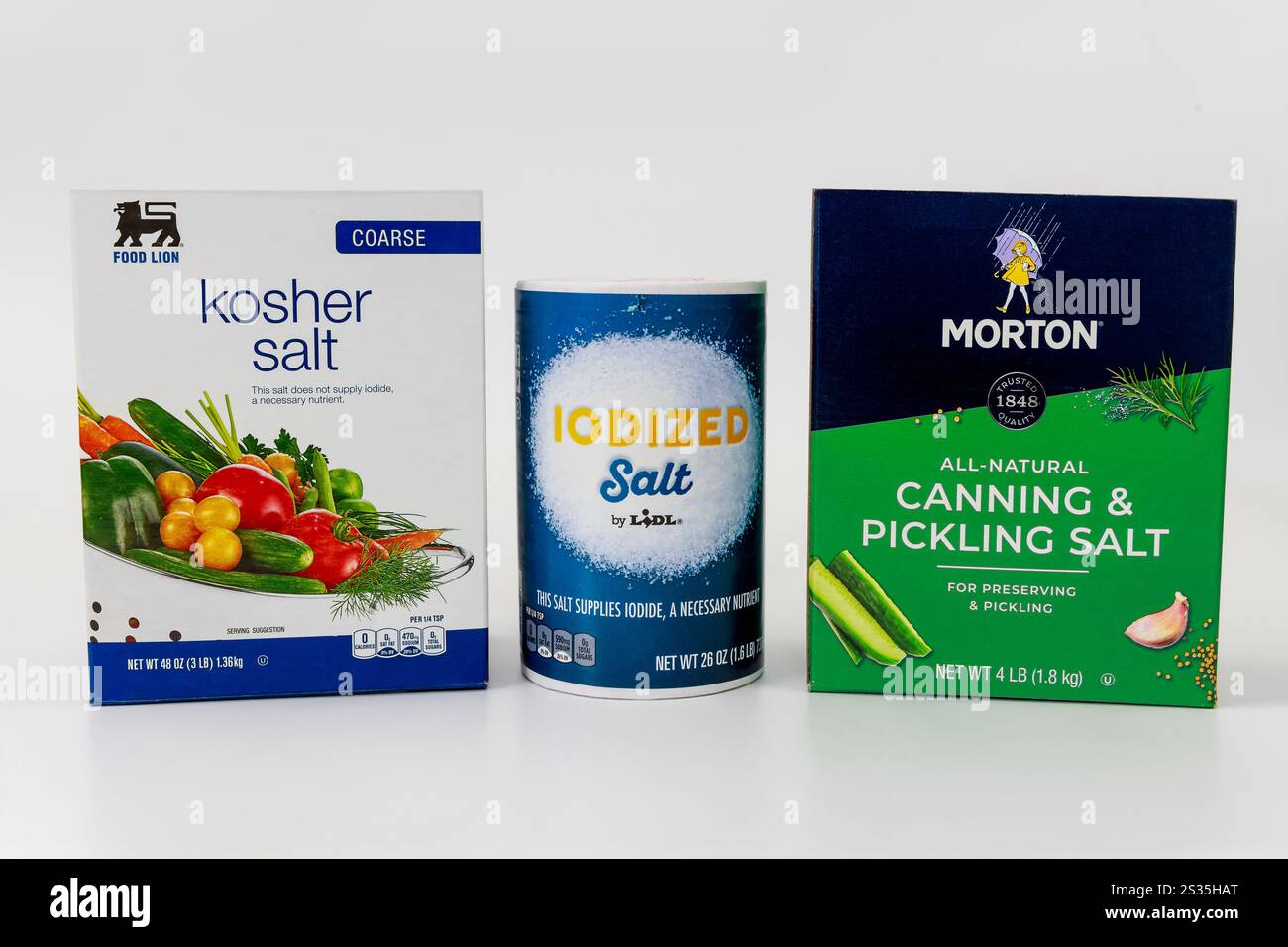 Different types of salt for cooking and canning displayed on white ...