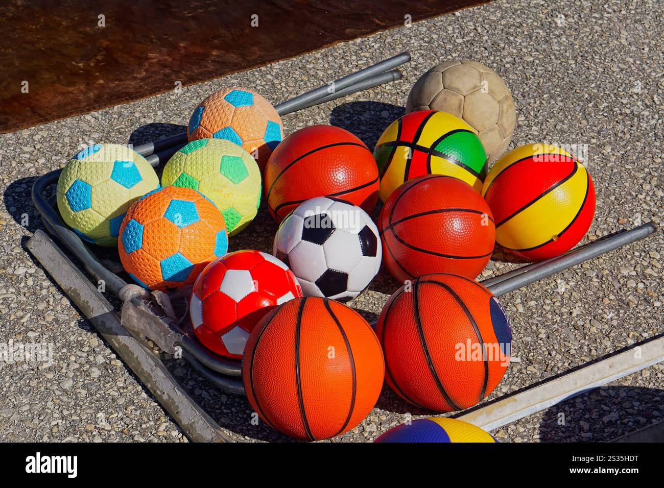 Collection of colorful balls for different sports at concrete ...