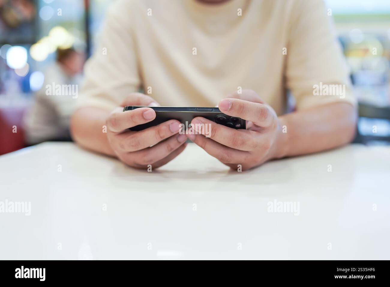 Man playing game on mobile phone. gamer boy playing video games holding ...