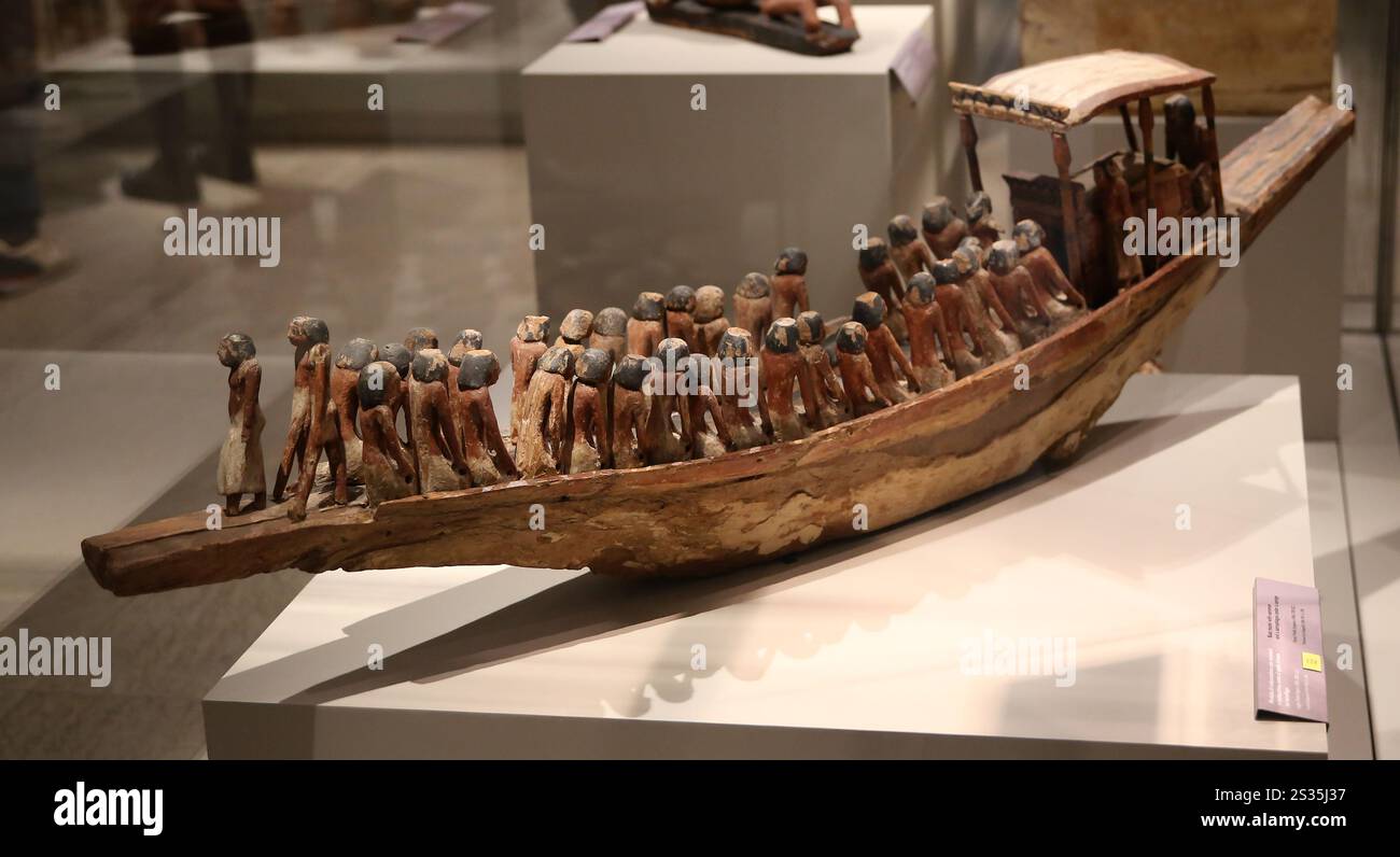 Model of a funerary boat with oarsmen and a sarcophagus under a canope ...