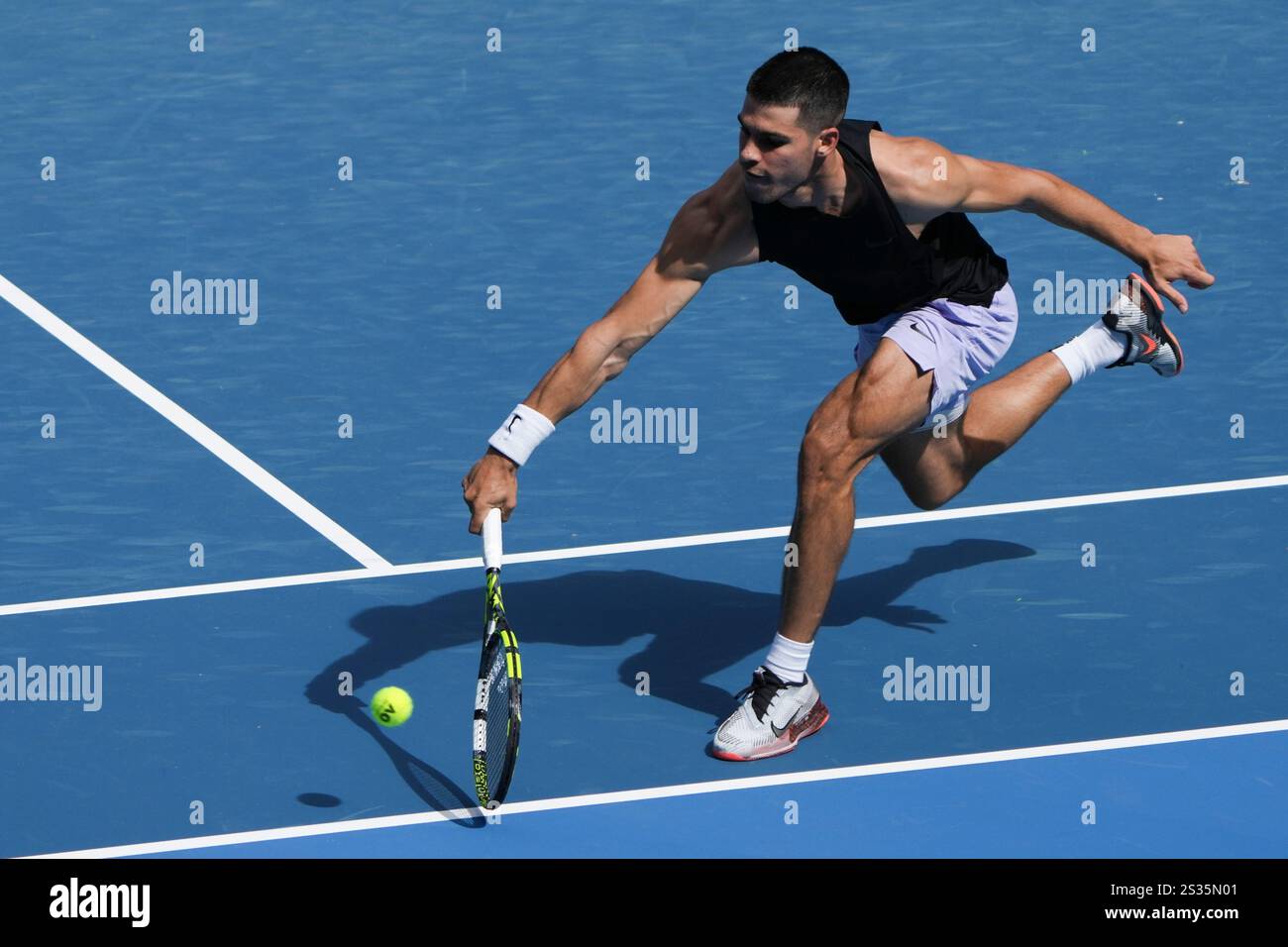 Spain's Carlos Alcaraz plays a backhand return to during a practice ...