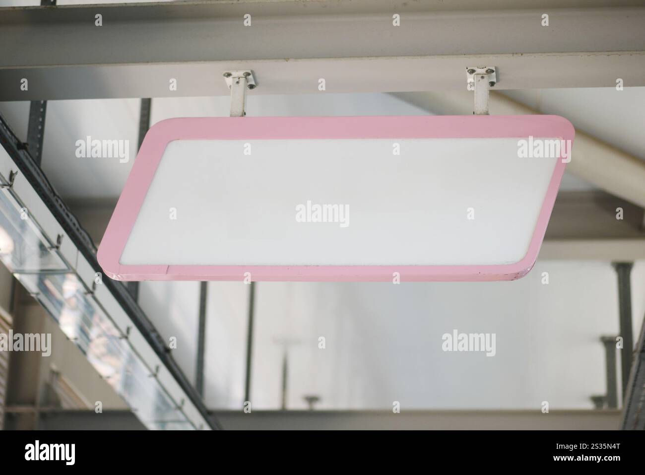 Hanging Pink Blank Sign Set Against a Stylish Industrial Background ...