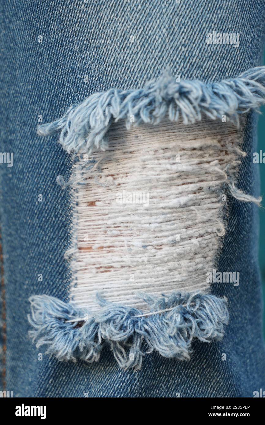 blue jean texture with a hole and ripped threads showing Stock Photo ...