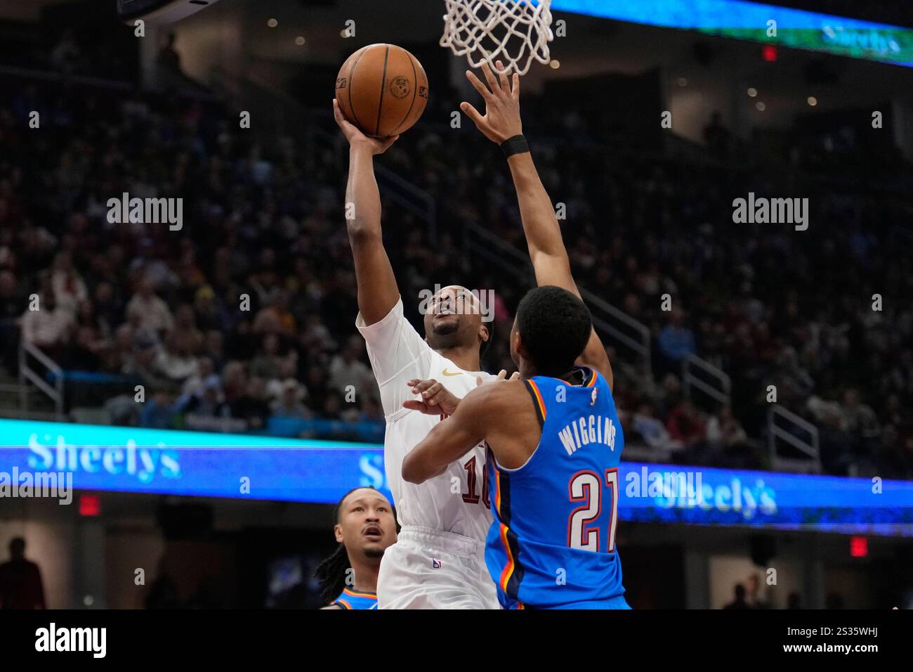 Cleveland Cavaliers guard Darius Garland shoots as Oklahoma City Thunder guard Aaron Wiggins (21 ...