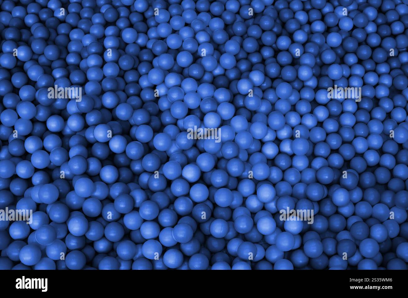 Many plastic balls in a kids ballpit at a playground. Close up pattern ...