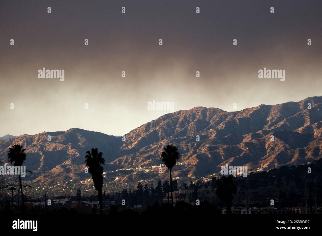 Heavy brown smoke layer over distant hills and palm trees in Los ...