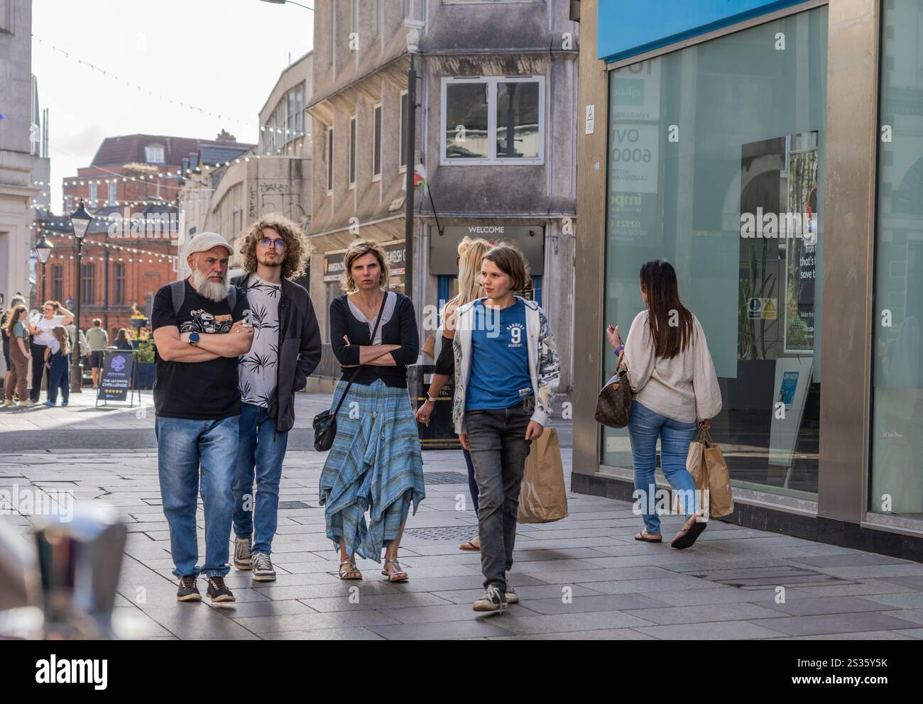 Cardiff Wales - August 6 2024: City street scene with group of four ...
