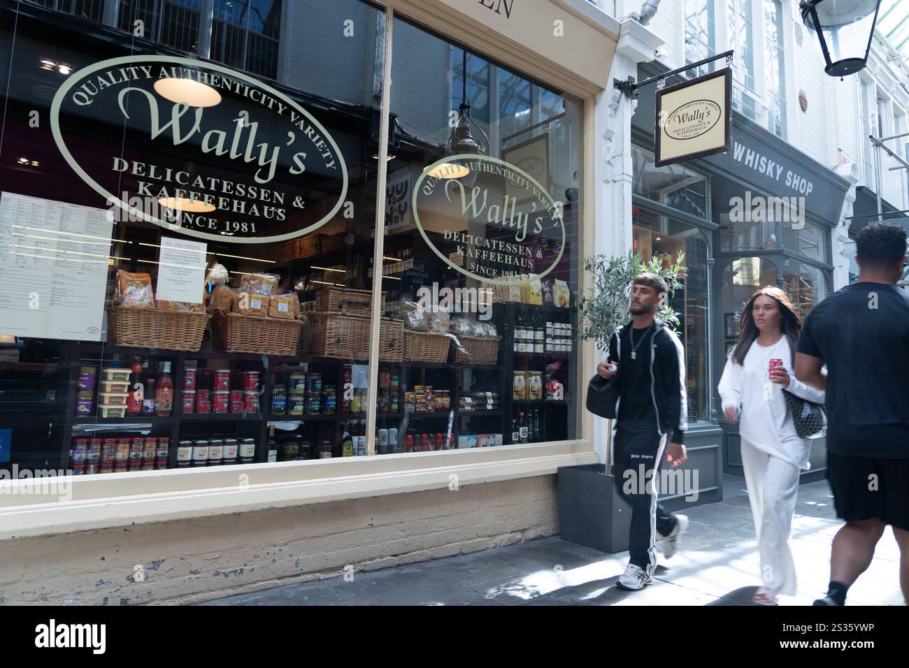 Cardiff Wales - August 6 2024: People and store fronts including Wally ...