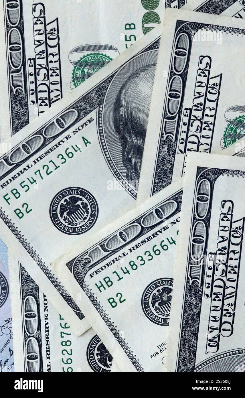 Background of 100 dollar bills. Abstract textured backdrop with many hundred money bills. Rich ...