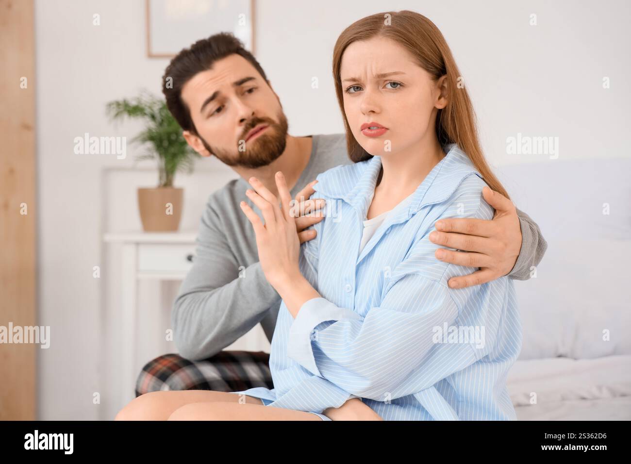 Young woman refusing to forgive her husband in bedroom Stock Photo - Alamy
