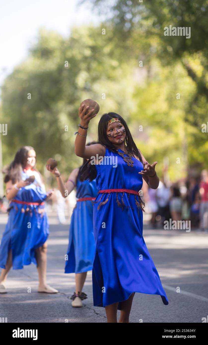 Woman wearing traditional clothing dancing during a parade celebrating ...