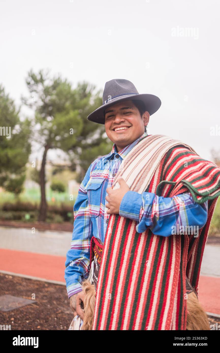 Portrait of smiling ecuadorian man wearing traditional poncho and hat ...
