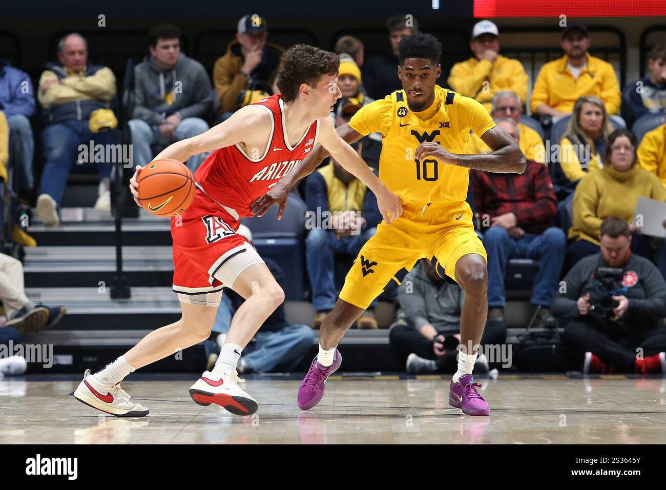 Arizona guard Anthony Dell'Orso, left, is defended by West Virginia ...