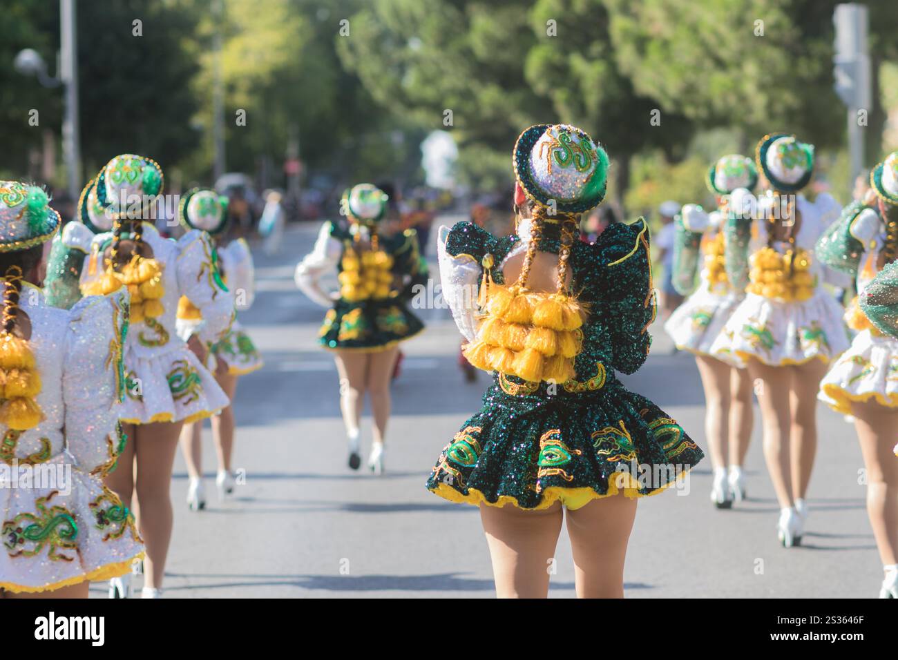 Lively parade of dancers wearing colorful traditional costumes ...