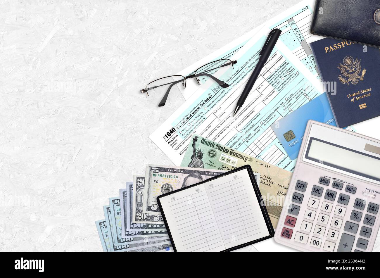 IRS form 1040 U.S. Individual income tax return with refund check lies ...